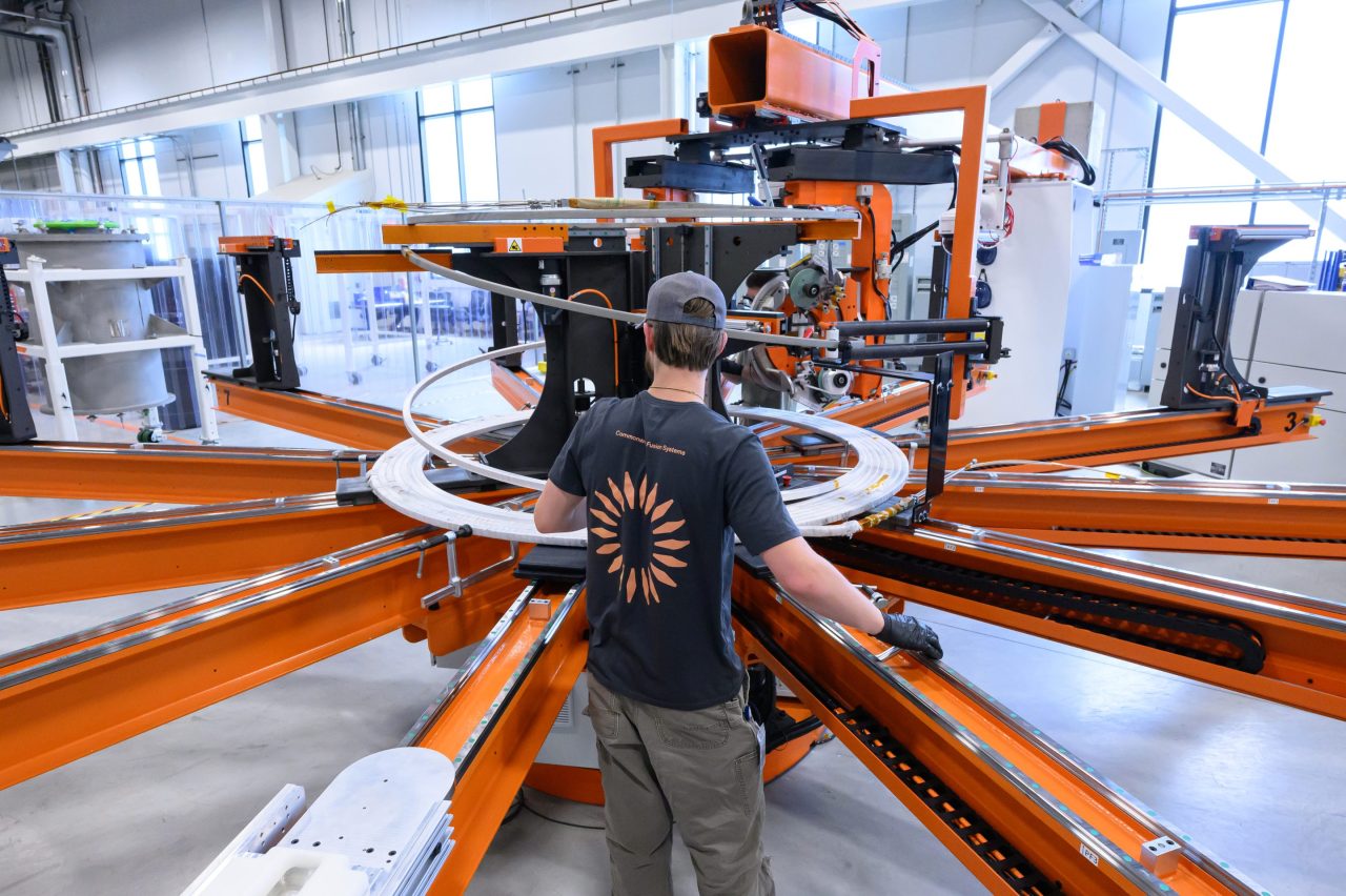 A Commonwealth Fusion team member operates a machine for making ...